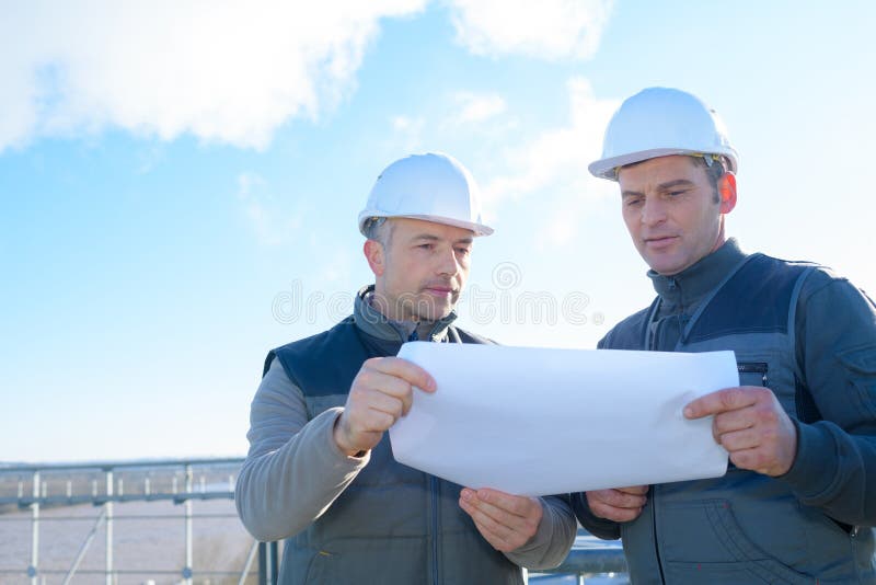 Two Engineers Checking Architectural Plan Outdoors Stock Photo - Image ...
