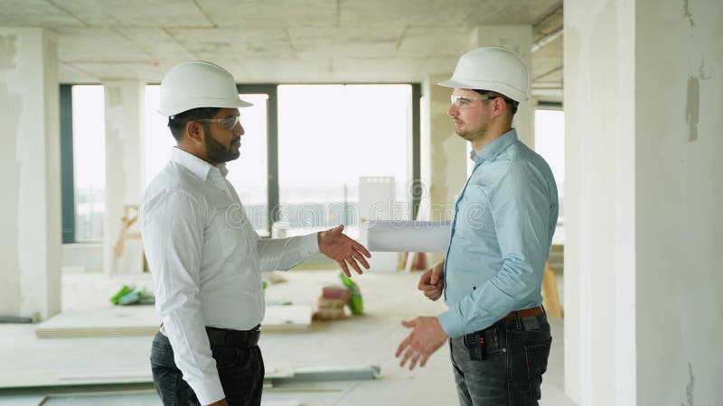 Engineer and Colleague Reviewing Construction Plans Stock Video - Video ...