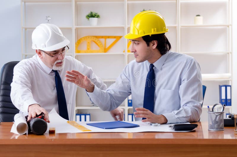 The Two Engineers Colleagues Working Under Project Stock Image - Image ...
