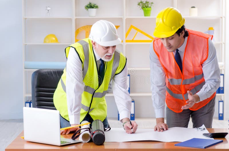The Two Engineers Colleagues Working Under Project Stock Photo - Image ...