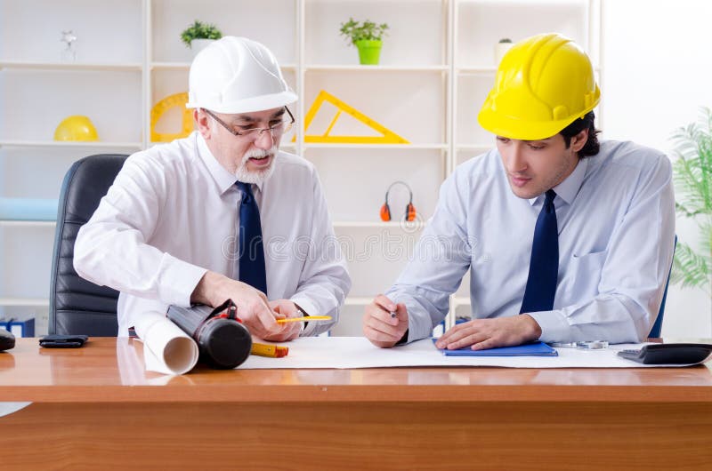The Two Engineers Colleagues Working Under Project Stock Photo - Image ...