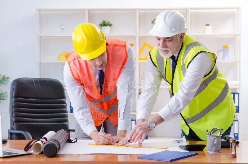 The Two Engineers Colleagues Working Under Project Stock Image - Image ...