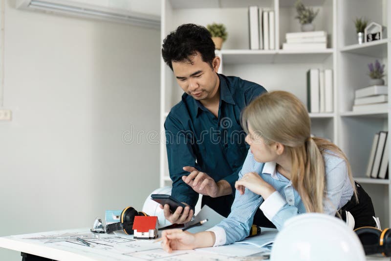 Engineers Collaborating on Architectural Design Project in Modern ...
