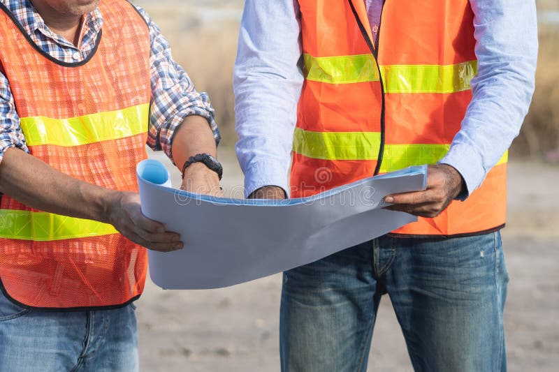 Two Engineers Discussing on Blueprint of Project Stock Photo - Image of ...