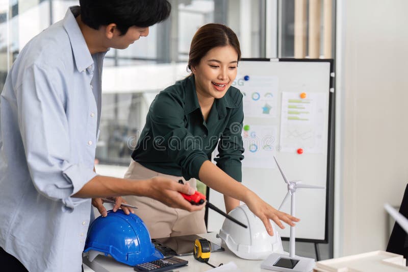 Sustainability in Action. Engineers Collaborating on Renewable Energy ...