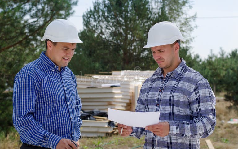 Two Engineers Having a Discussion on Site Stock Photo - Image of ...