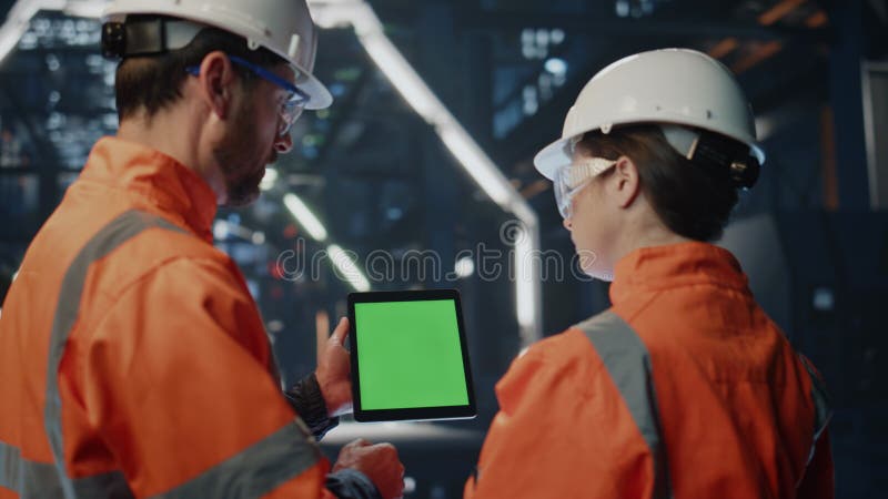 Two Engineers Looking Mockup Tablet Discussing Technical Data on ...