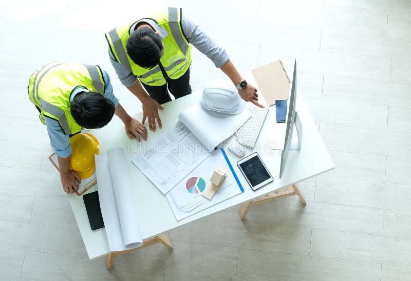Two Engineers Man Looking at Blueprint Drawing Project Plan on the ...