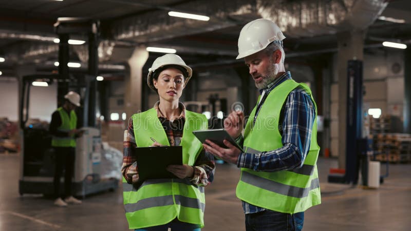 Two Engineers, Man and Woman, Standing Discussing Work Details ...