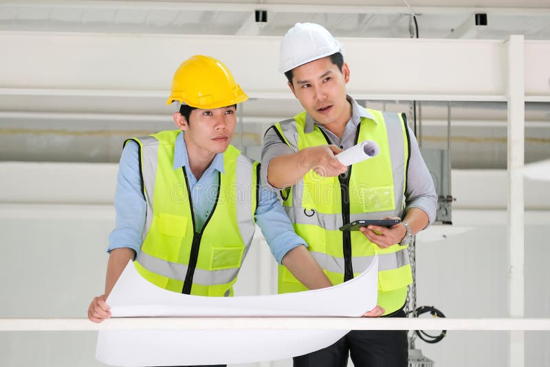 Two Engineers Man Standing in the Construction Plant. Right Engineer ...