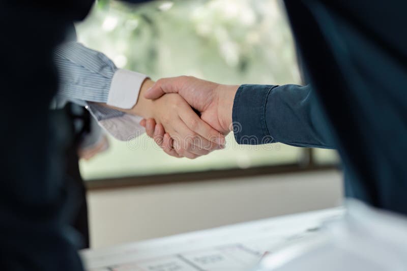 Engineers Shaking Hands in Agreement Over Architectural Project ...