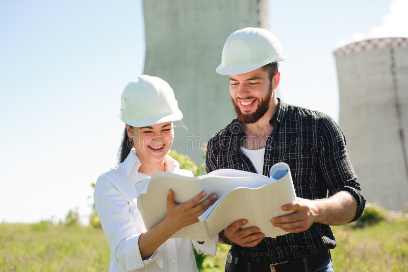 Two Engineers Standing at Electricity Station, Discussing Plan. Stock ...