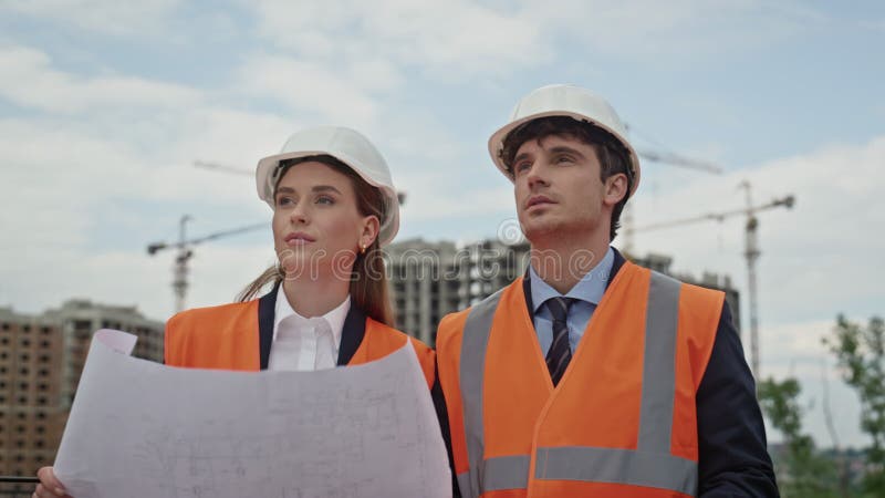 Two Engineers Study Blueprint at City Construction Site Closeup ...