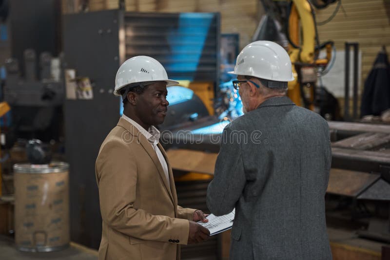 Two Engineers Talking in Modern Factory Stock Photo - Image of industry ...