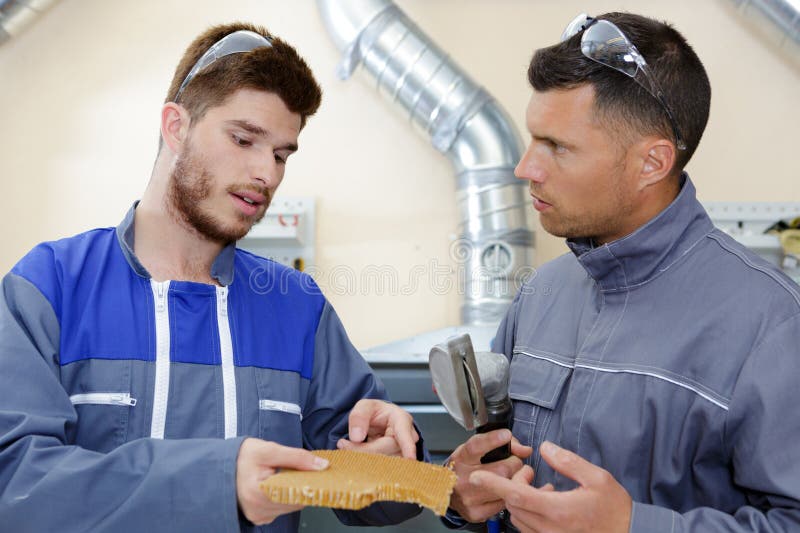 Two Engineers Talking and Pointing To Problem Stock Photo - Image of ...