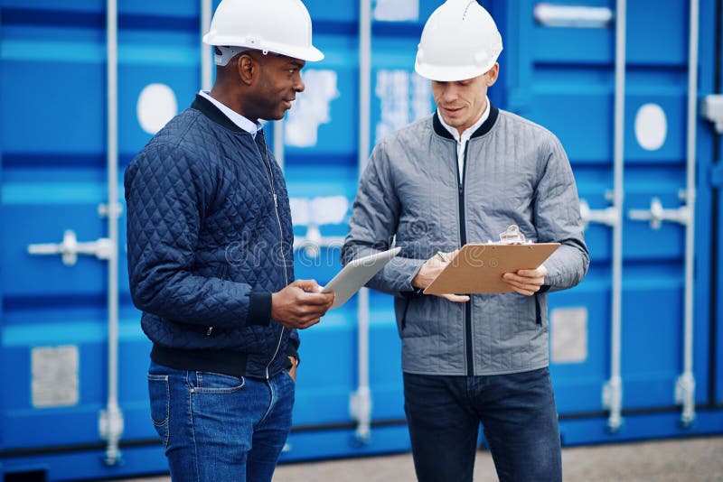 Two Engineers Tracking Freight Containers in a Shipping Yard Stock ...