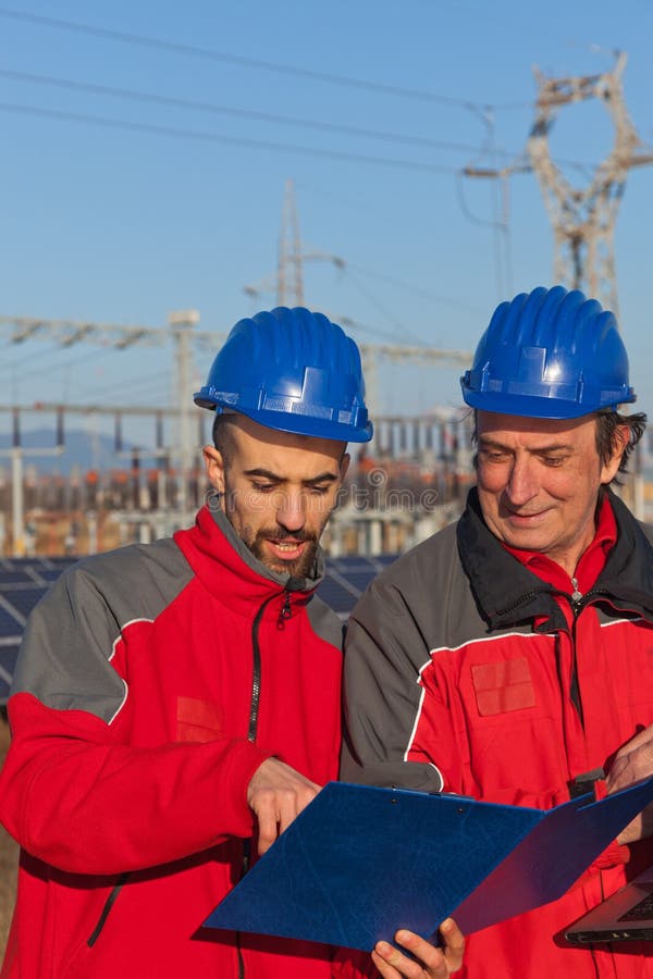 Two Engineers at Work stock image. Image of outdoors - 18393779
