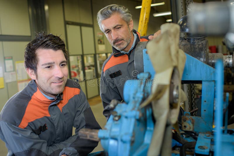 Two engineers at work stock image. Image of workshop - 118892445