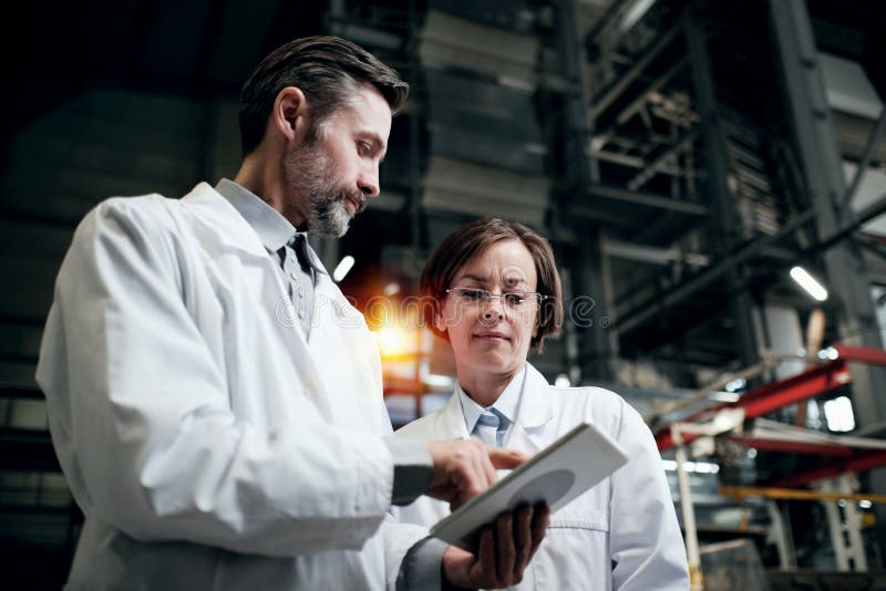 Two Engineers Working at the Factory on the Tablet Stock Photo - Image ...