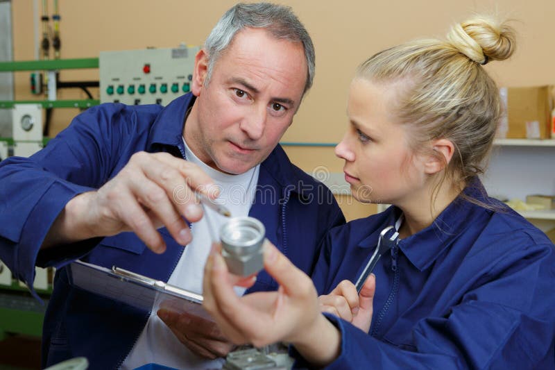 Two Engineers Working with Metal Objects Stock Image - Image of ...