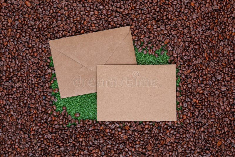 Two Envelopes on Grass Surrounded by Coffee Beans, Aligned in the ...