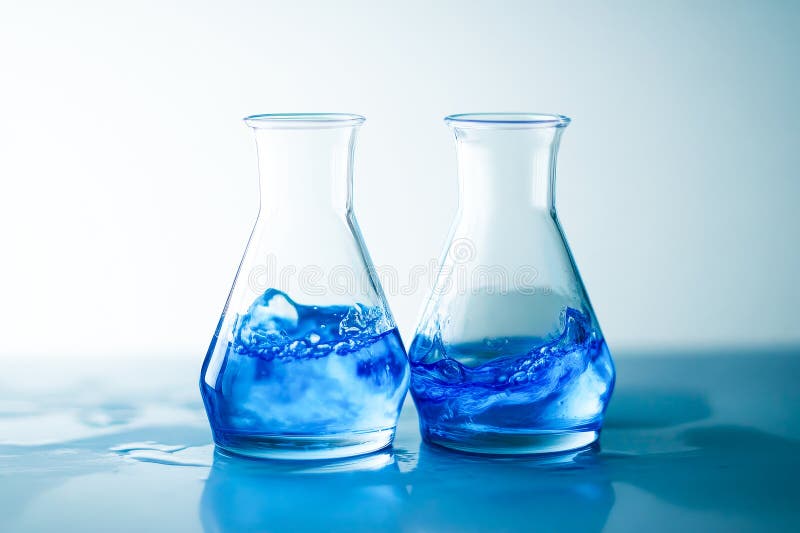 Two Erlenmeyer Flasks Containing Shaking Blue Liquid for Scientific ...