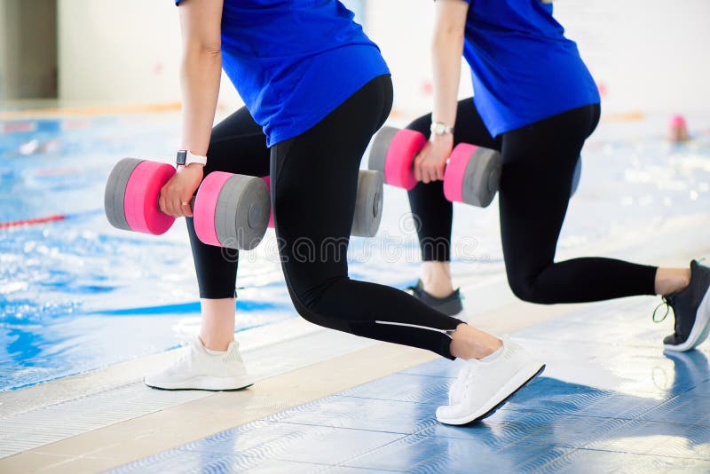 Two Erobics Trainers Show the Workout Exercises in Front of the Pool ...