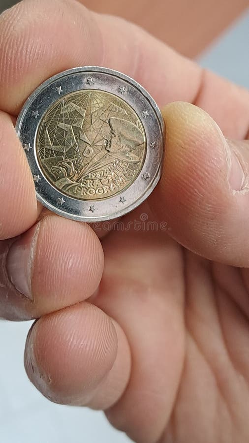 Two Euro Coin between Fingers Stock Photo - Image of money, pocket ...