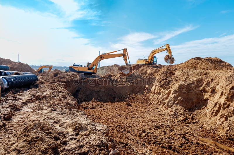 Two Excavator are Digging Soil in the Construction Site on Sky ...