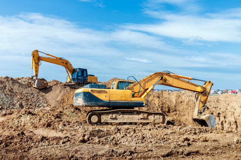 Two Excavator are Digging Soil in the Construction Site on Sky ...