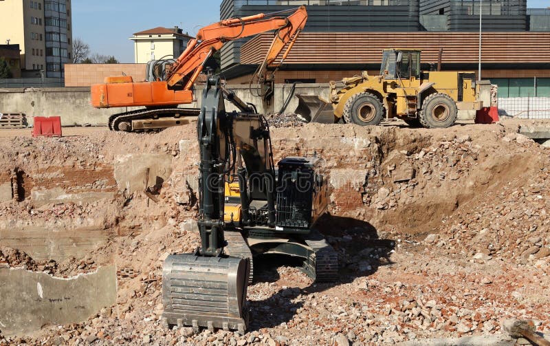 Two Excavators and a Bulldozer during a Redevelopment of an Urban Area ...