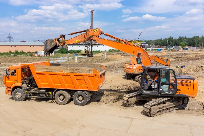 Two Excavators Load the Earth into a Dump Truck Editorial Stock Photo ...