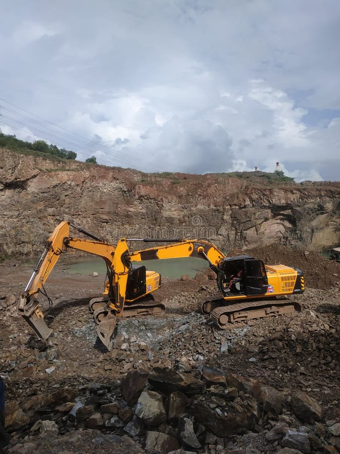Two Excavators are Running Rock Mining Activities Stock Photo - Image ...