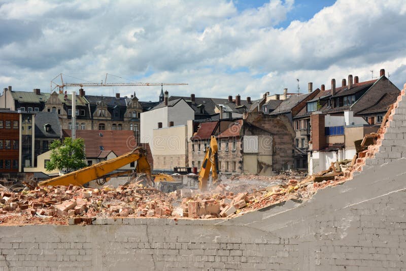 Two Excavators are Sorting through the Rubble of Buildings Destroyed ...