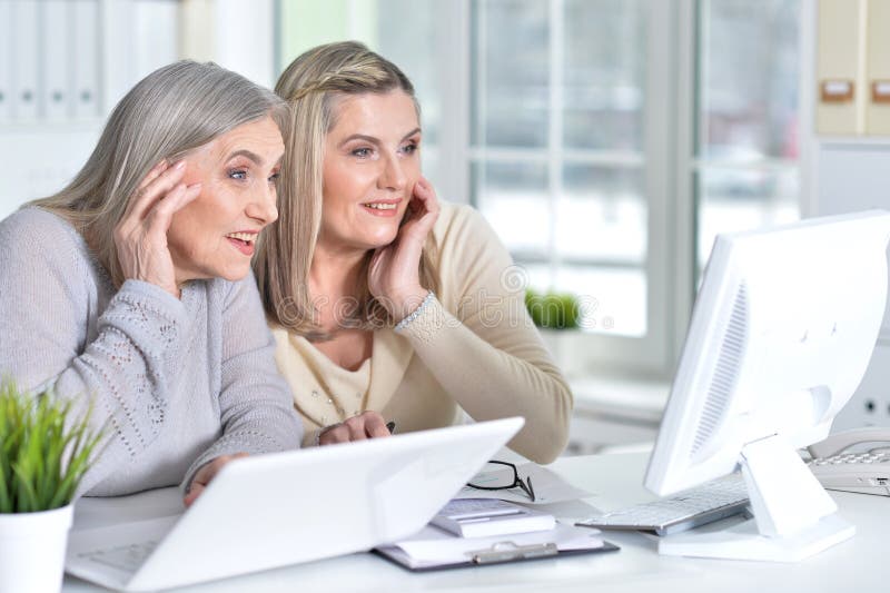 Two Excited Mature Women Working in Office Stock Photo - Image of ...