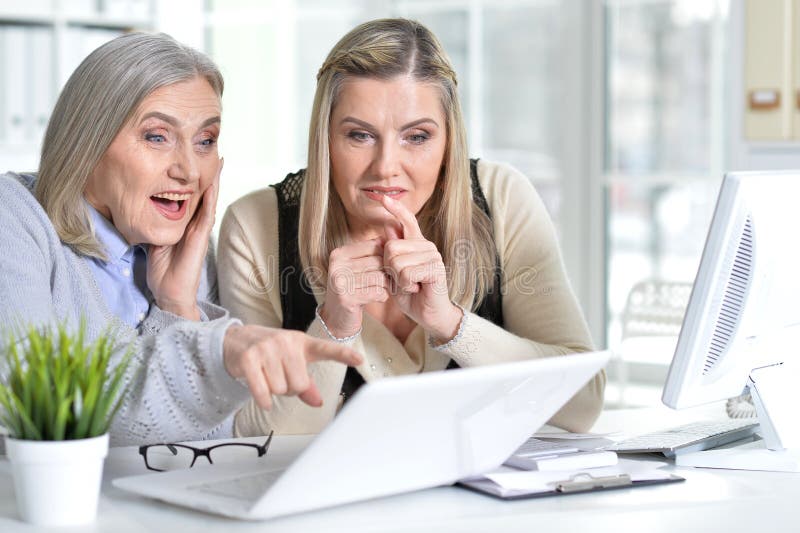 Two Excited Mature Women Working in Office Stock Photo - Image of ...