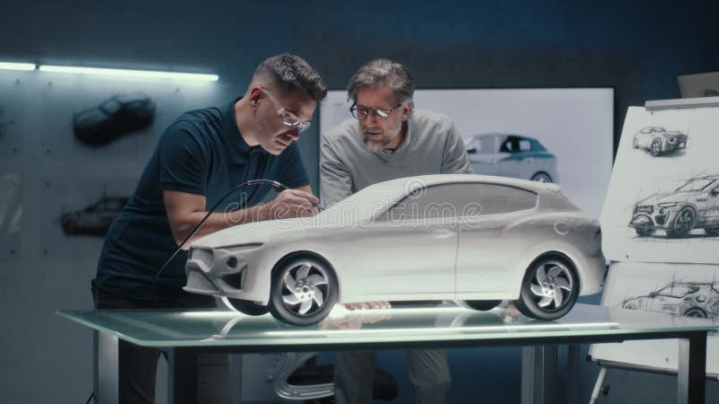 Automotive Design Engineers Discuss Design of Car Looking at the Pencil ...
