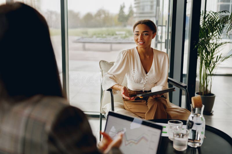 Professional Meeting Taking Place in a Modern Office Setting Focused on ...