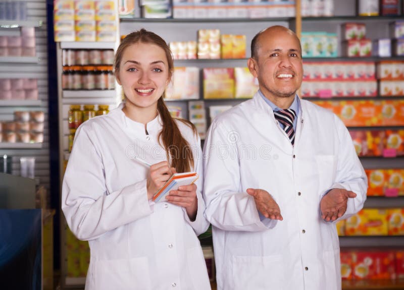 Two experts in drugstore stock image. Image of pharmaceutical - 72429091