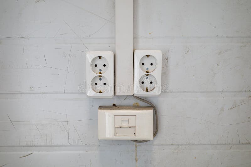 Two External Electrical Double Sockets on a Dirty White Scratched Wall ...