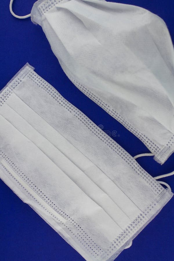 Two Face Masks on a Blue Background Stock Photo - Image of mouth ...