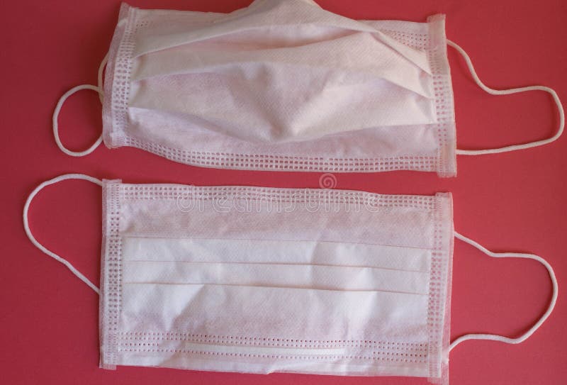 Two Face Masks on a Red Background Stock Photo - Image of blue, effect ...