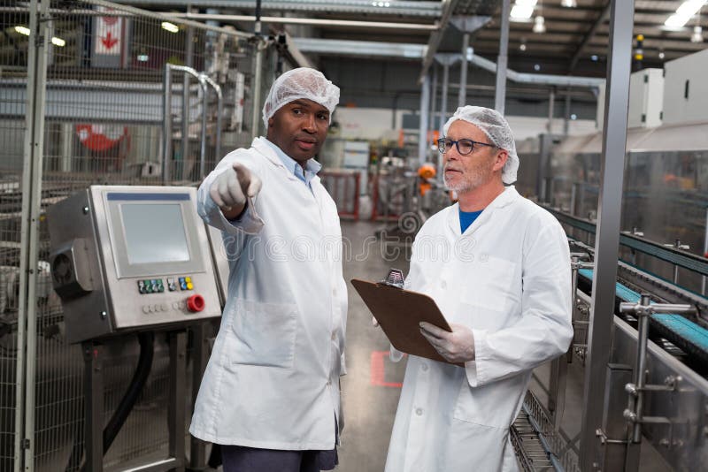 Two Factory Engineers Discussing with Each Other Stock Photo - Image of ...