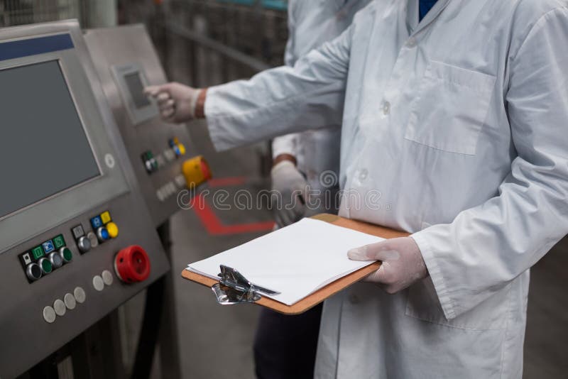 Two Factory Engineers Operating Machine in Factory Stock Image - Image ...