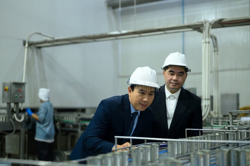 Two Factory Executives Discussing Operations Inside Food Manufacturing ...