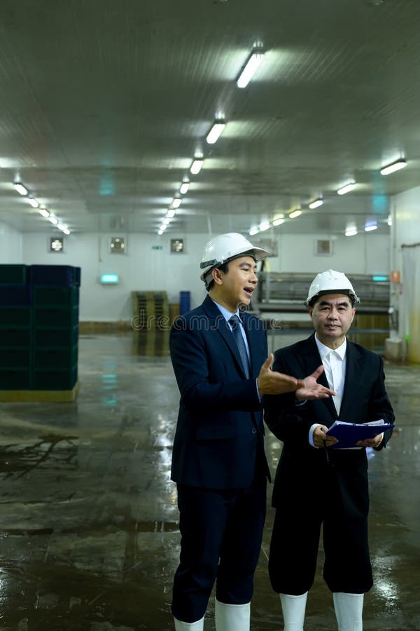 Two Factory Executives Discussing Operations Inside a Food ...