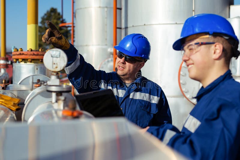 Two Factory Worker in a Hard Hat on Heavy Equipment and Pipeline Stock ...