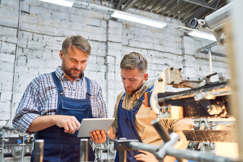Two Factory Workers Operating Modern Equipment Stock Image - Image of ...