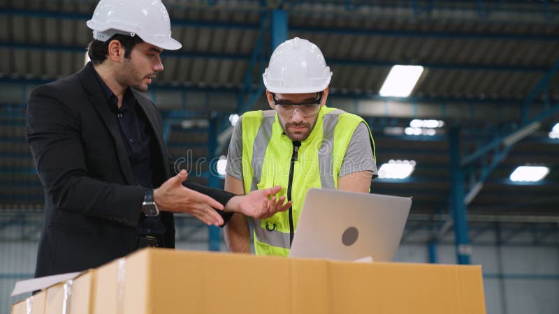 Two Factory Workers Working and Discussing Manufacturing Plan in the ...