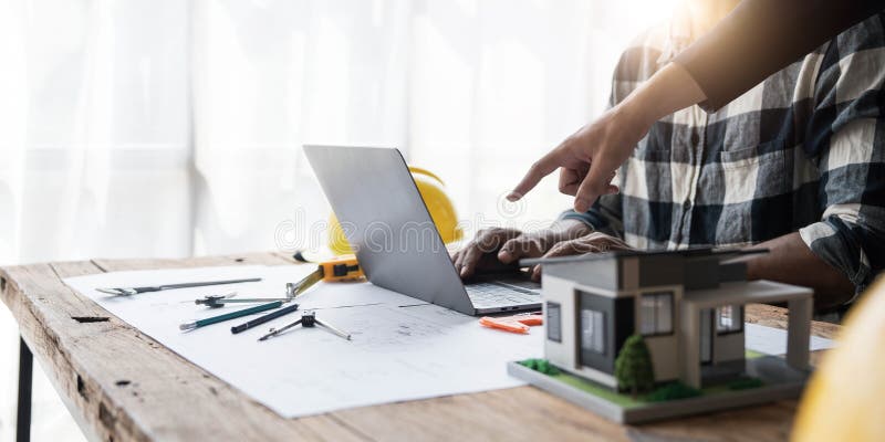 Two Factory Workers Working and Discussing Manufacturing Plan in the ...